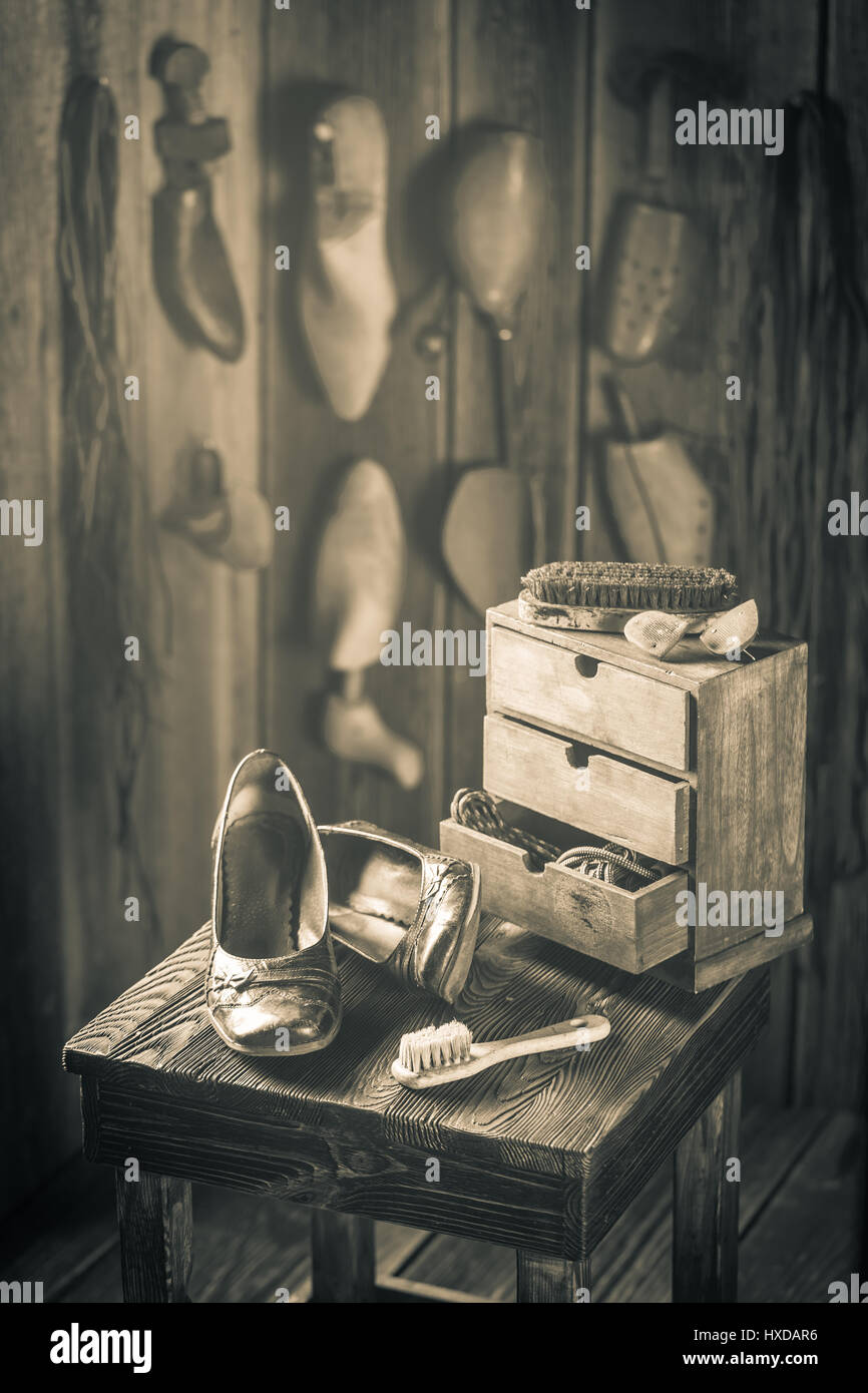Old shoemaker workplace with brush and shoes Stock Photo - Alamy