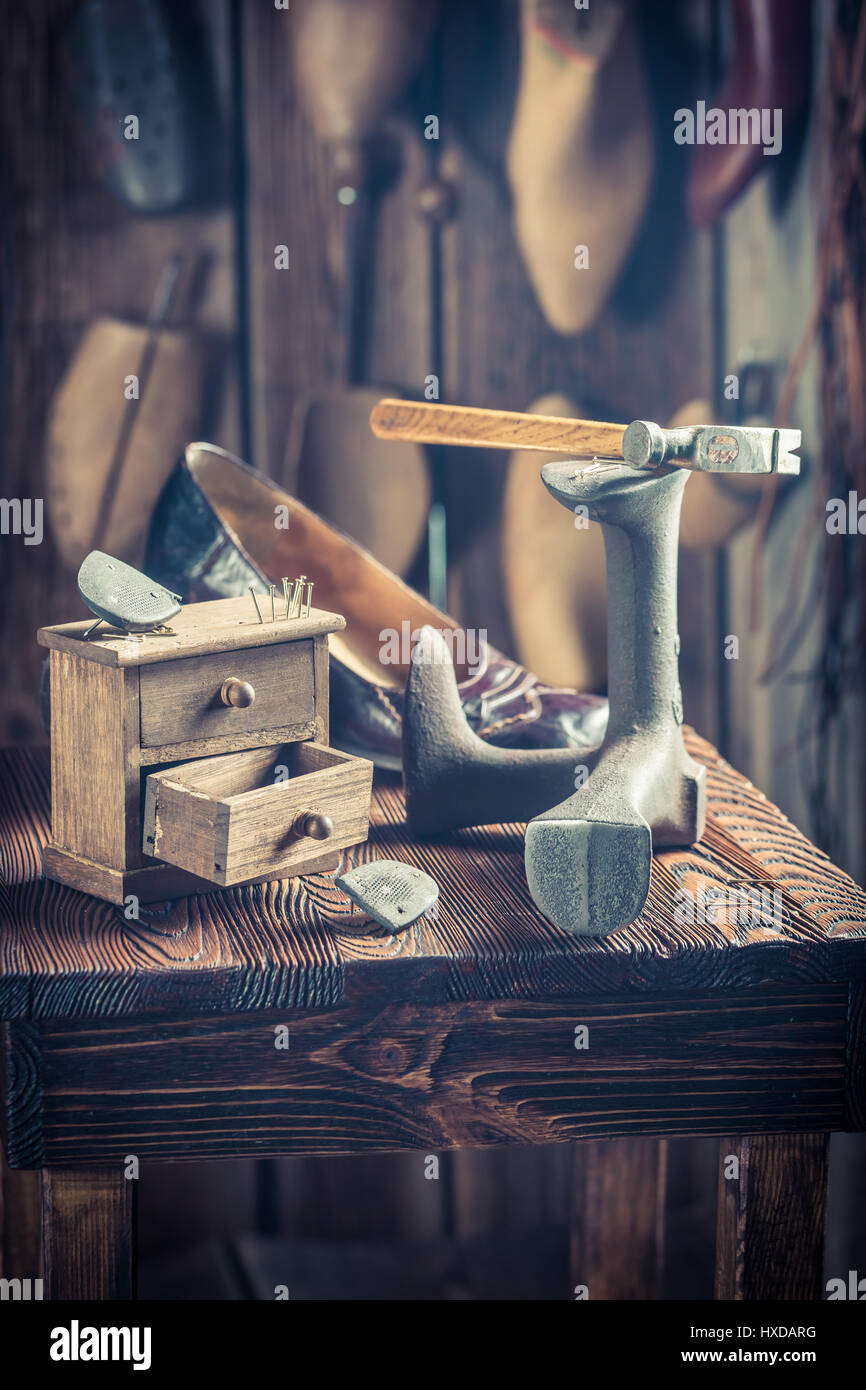 Old cobbler workshop with tools, shoes and laces Stock Photo - Alamy