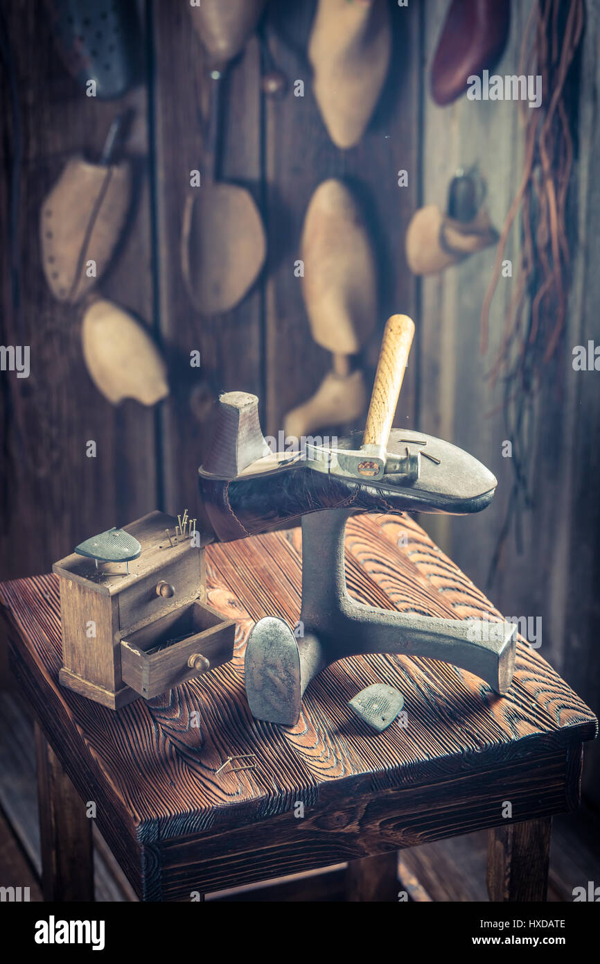 Old cobbler workplace with shoes, laces and tools Stock Photo - Alamy