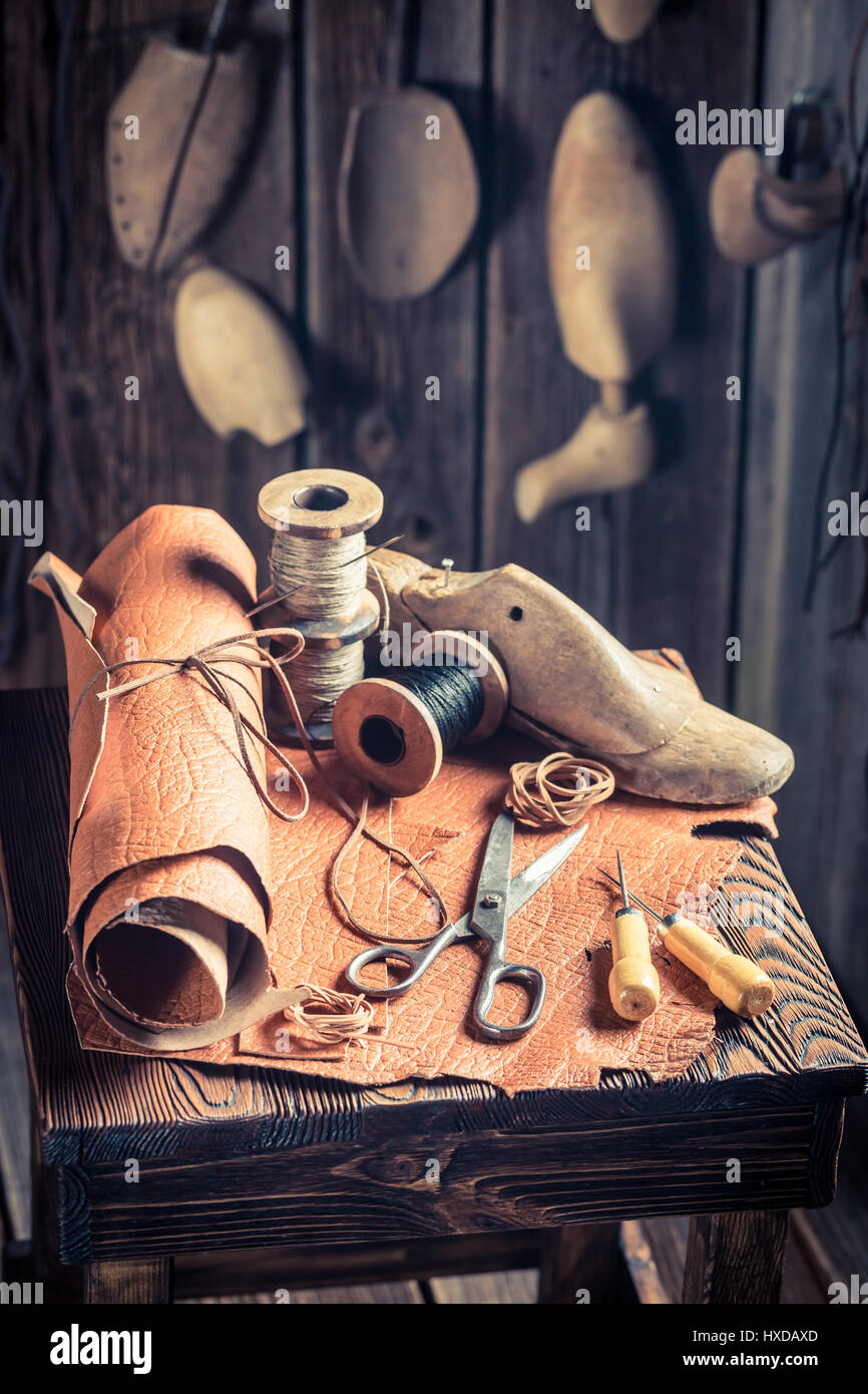Aged cobbler workplace with shoes, laces and tools Stock Photo - Alamy