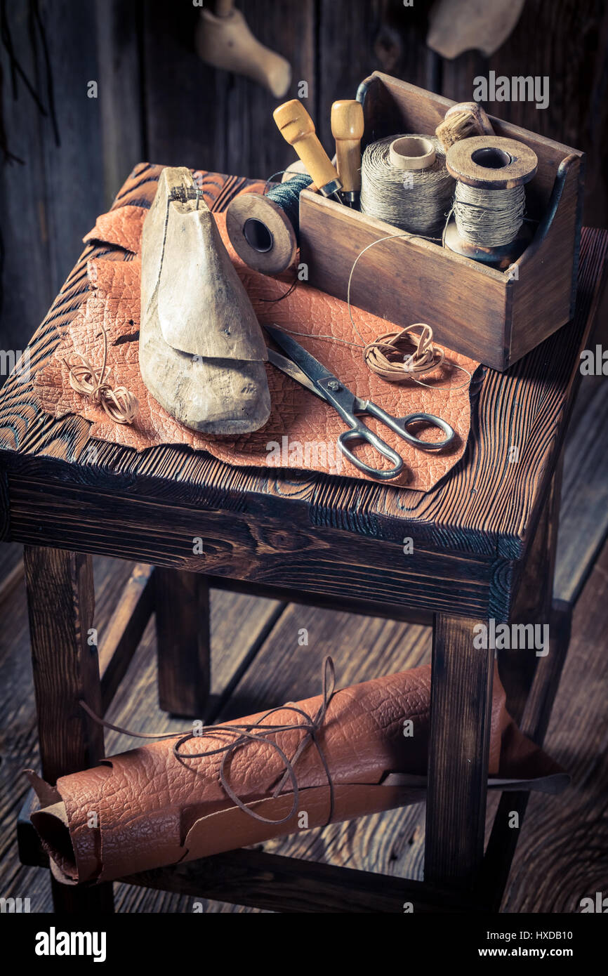 Small cobbler workshop with tools, shoes and laces Stock Photo - Alamy