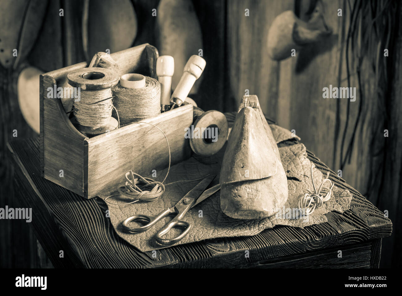 Small cobbler workplace with tools, shoes and leather Stock Photo - Alamy