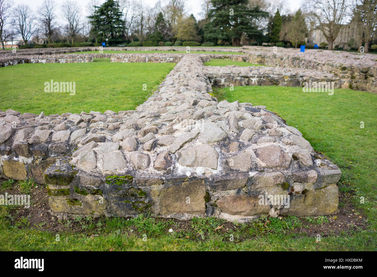 Stone walls in a park in the wintertime, trees in the background Stock ...