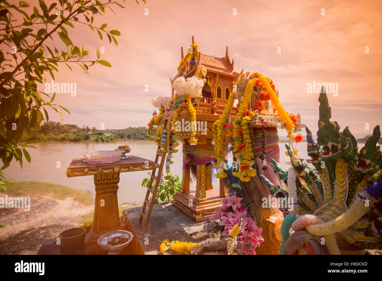 a spirit house at the landscape of the mekong river at the town of ...