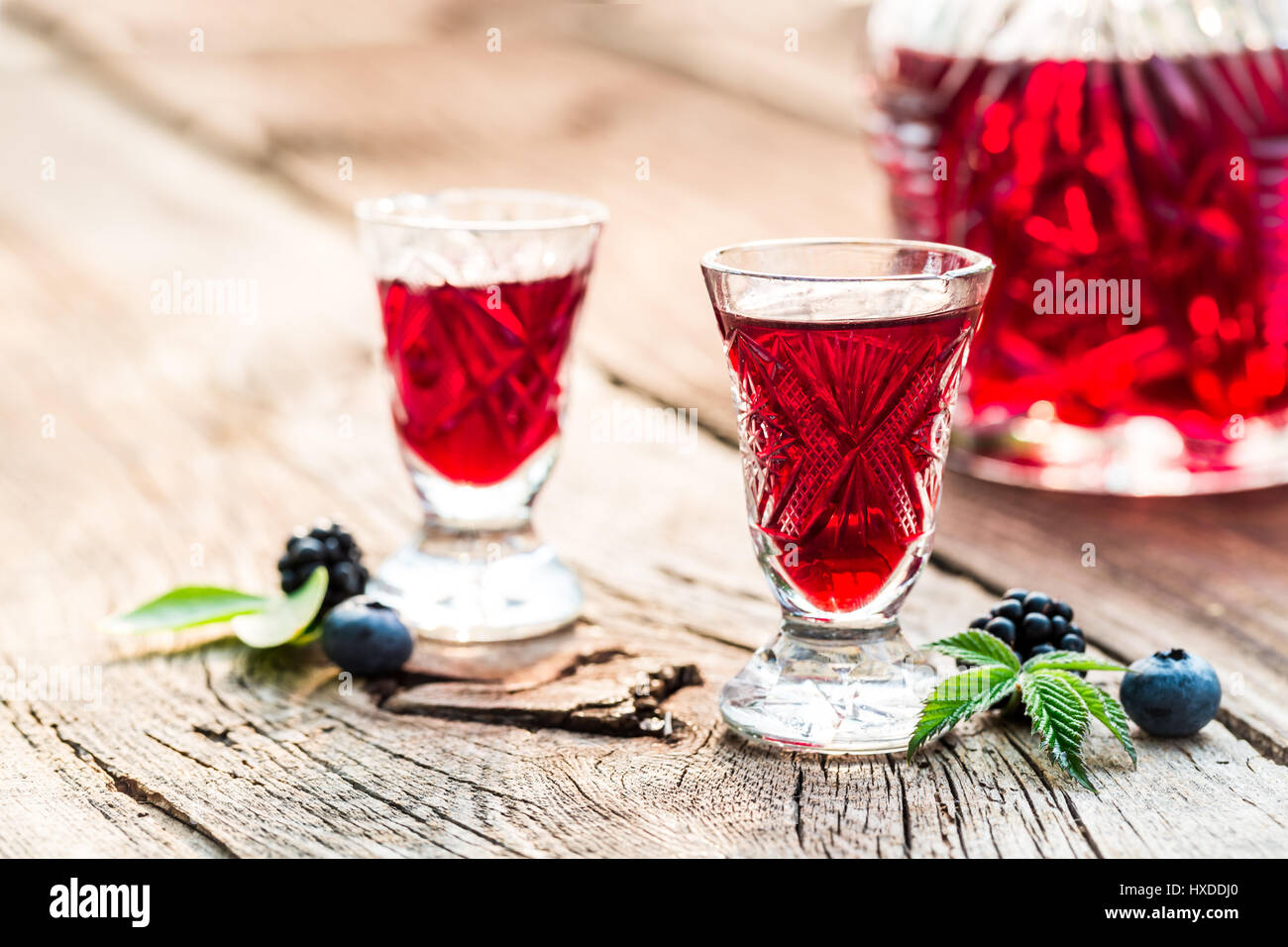Fresh liqueur made of berry fruits and alcohol Stock Photo - Alamy