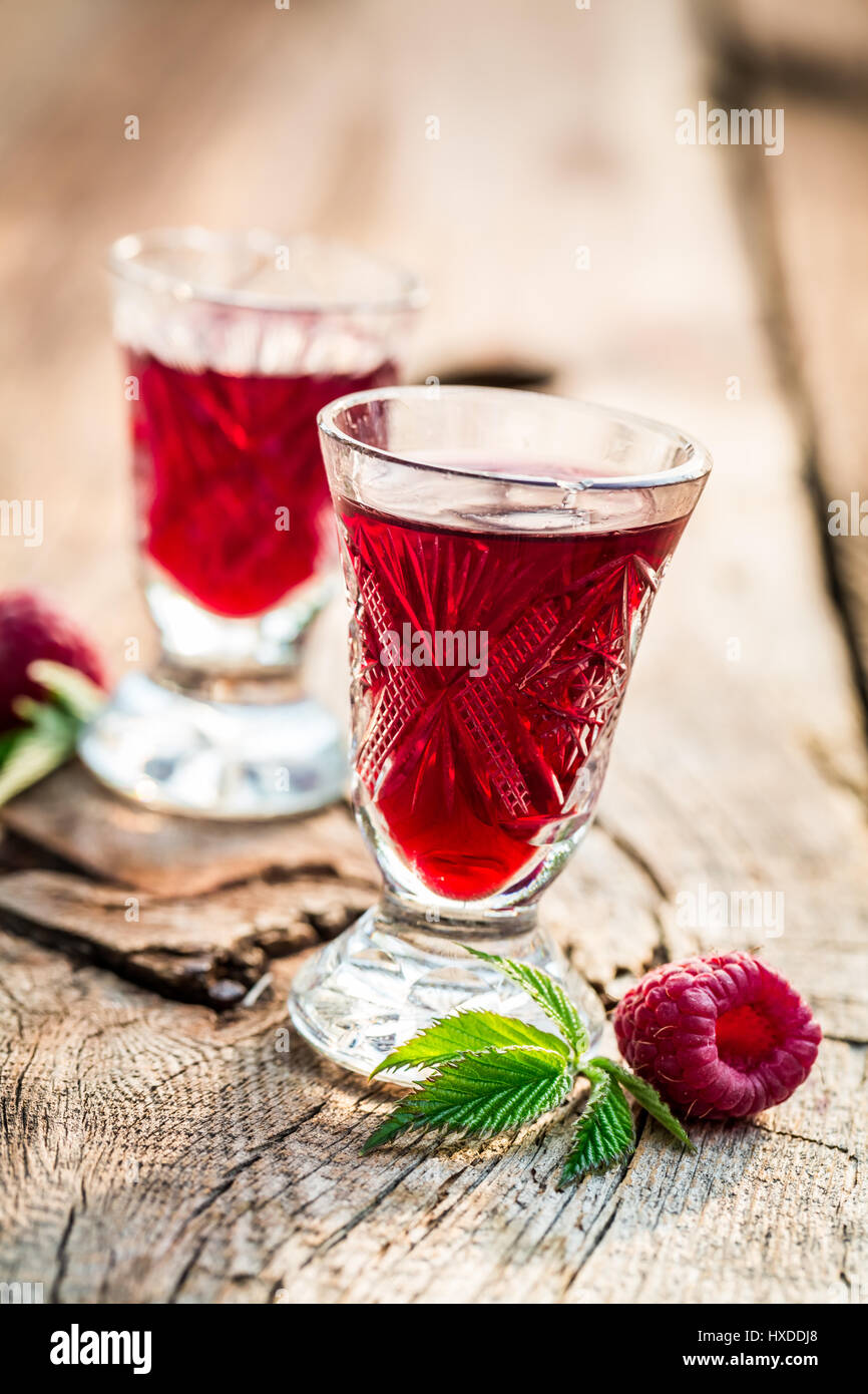 Homemade liqueur made of alcohol and raspberries Stock Photo - Alamy