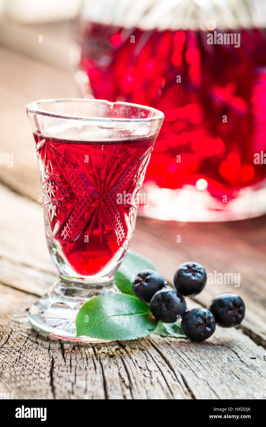 Homemade liqueur made of alcohol and chokeberries Stock Photo - Alamy