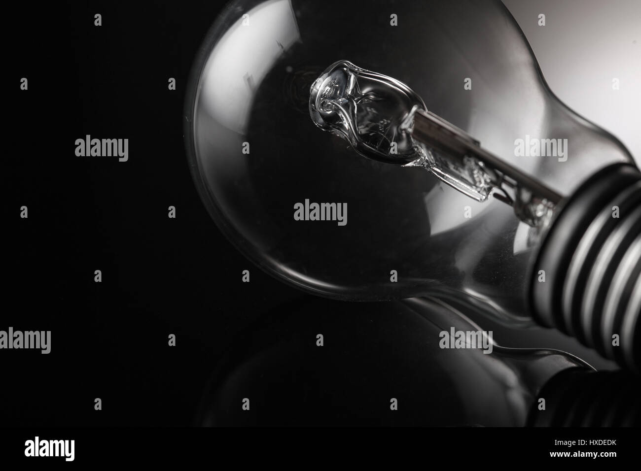 light bulb on dark black background Stock Photo - Alamy