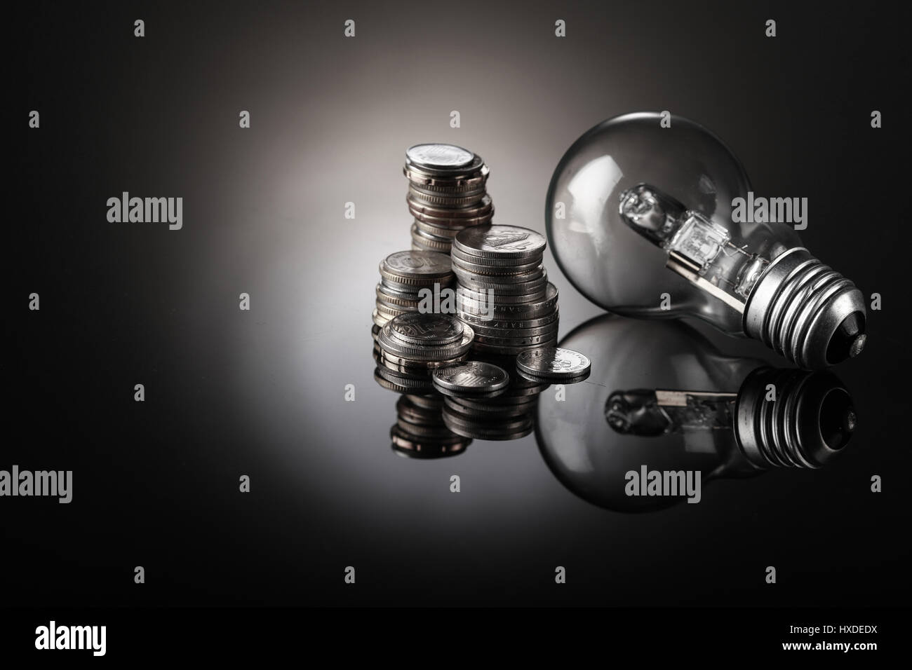 light bulb with stack of coins concept Stock Photo - Alamy