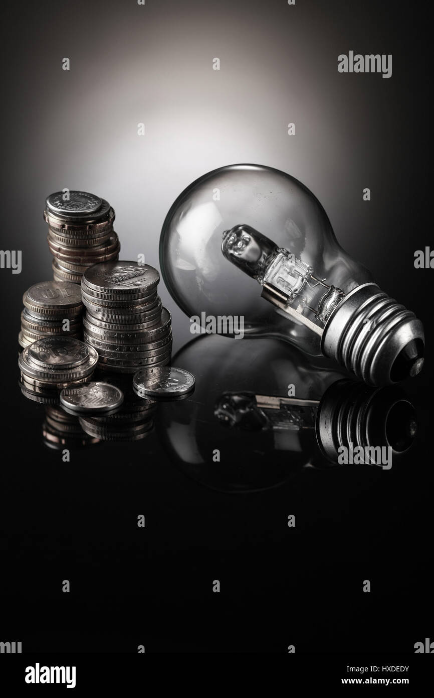 light bulb with stack of coins concept Stock Photo - Alamy
