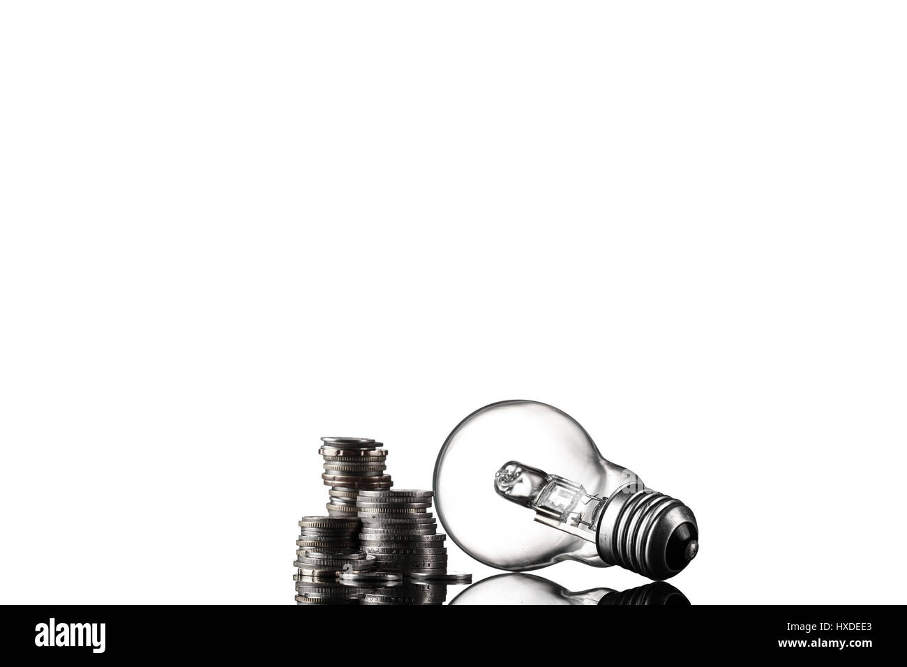 light bulb with stack of coins concept Stock Photo - Alamy
