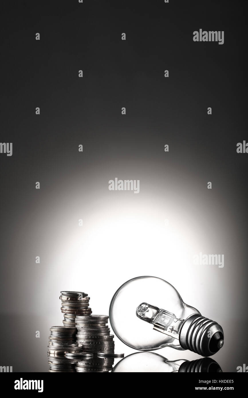 light bulb with stack of coins concept Stock Photo - Alamy