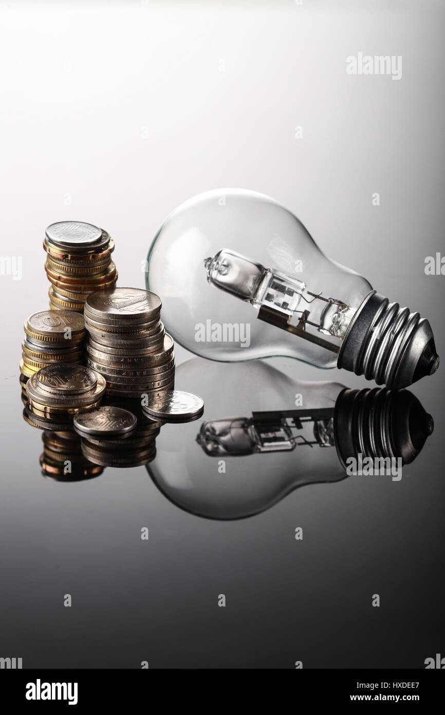light bulb with stack of coins concept Stock Photo - Alamy