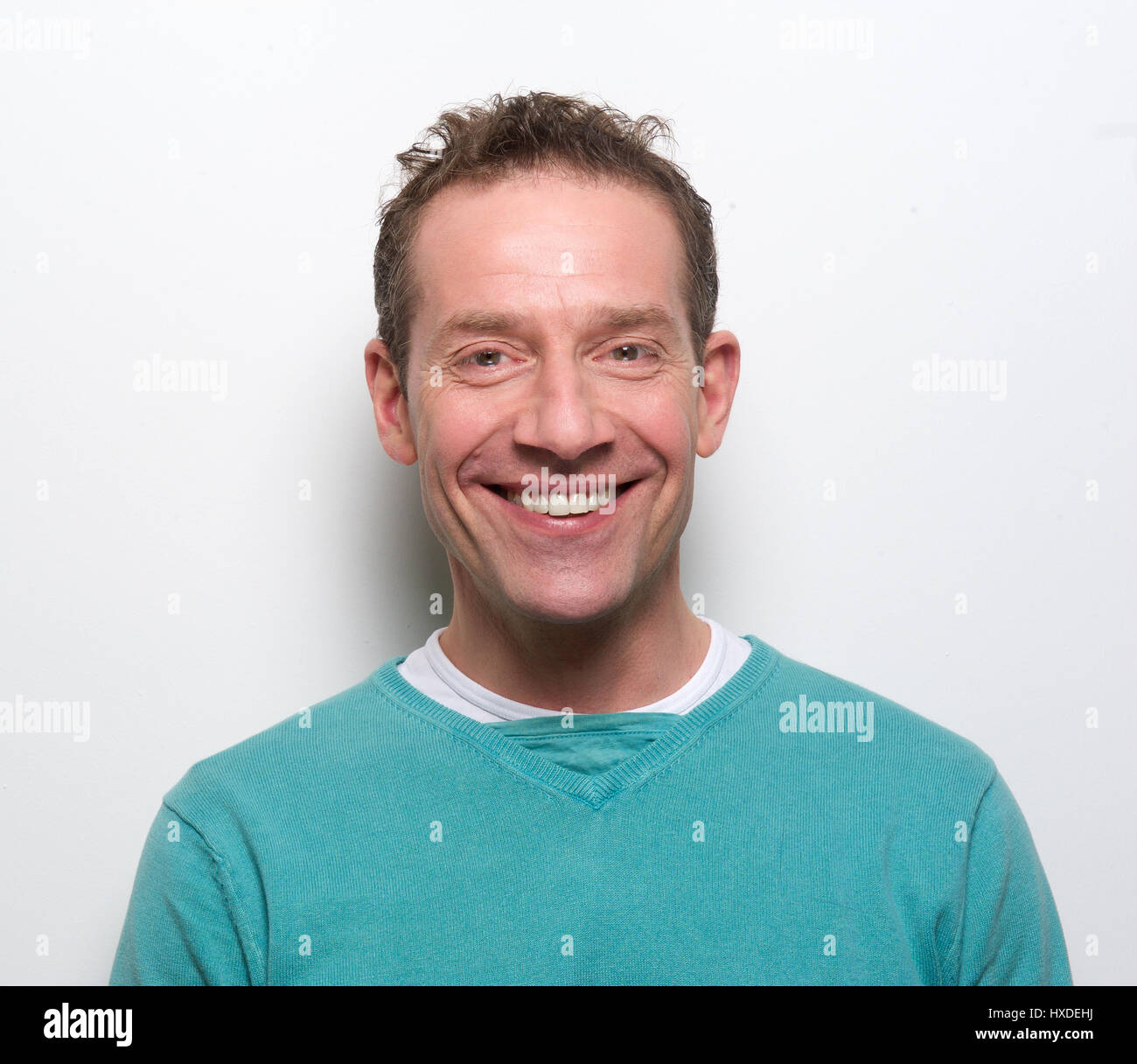 Close up portrait of a happy middle aged man smiling on white ...