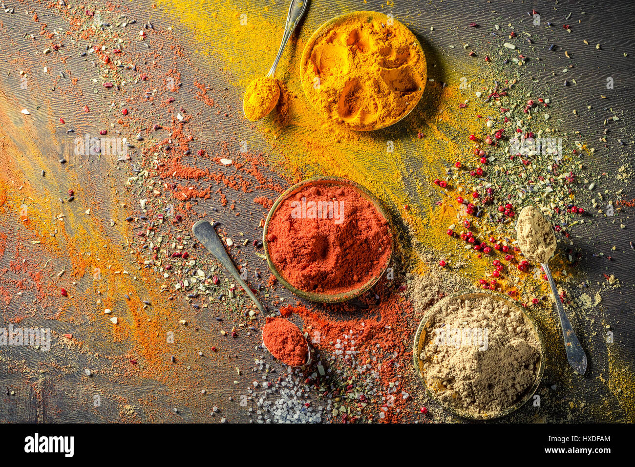 Mess with vivid spices on old board Stock Photo - Alamy