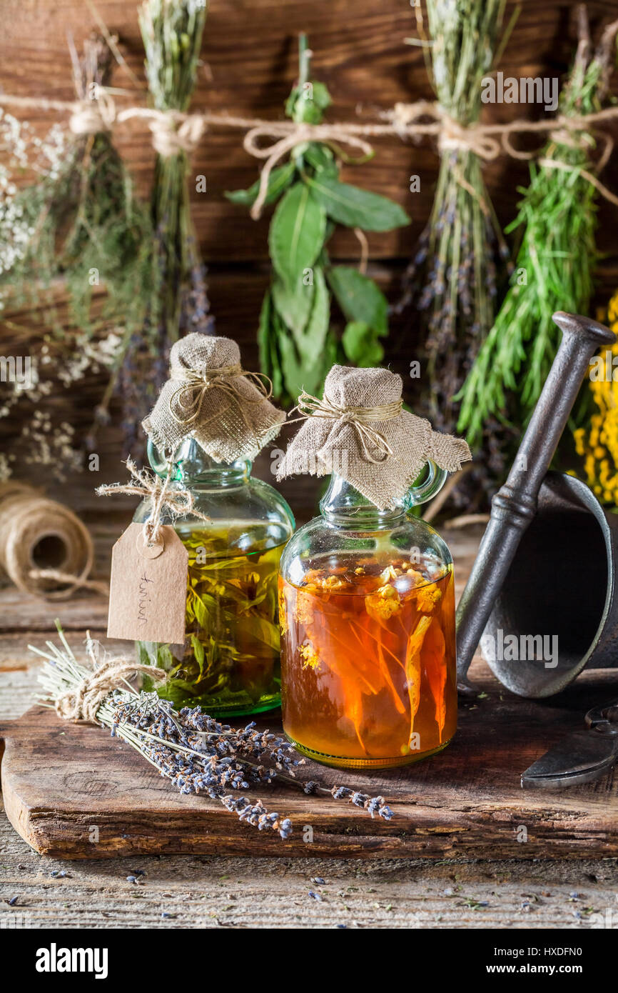 Therapeutic tincture with alcohol and fresh herbs Stock Photo - Alamy