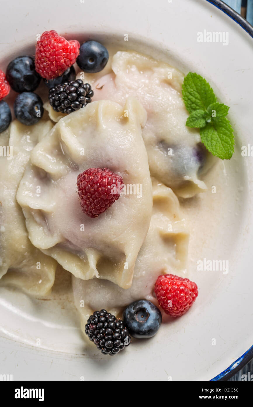 Closeup of sweet dumplings with berry fruits Stock Photo - Alamy