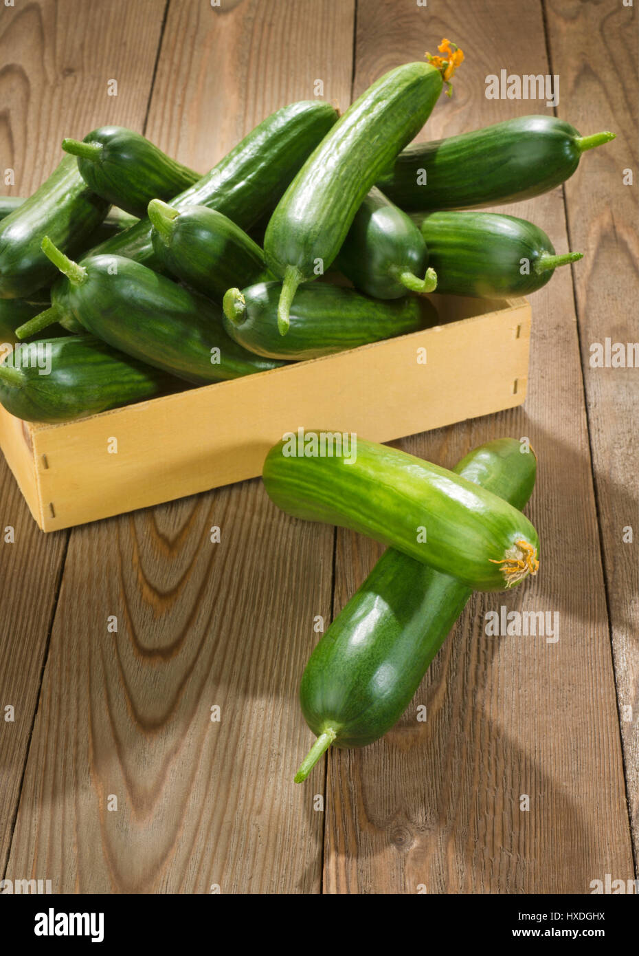 Cucumbers in a wooden box on a rustic table Stock Photo - Alamy