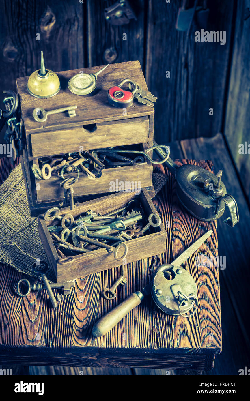 Tools, locks and keys in vintage locksmiths workshop Stock Photo - Alamy