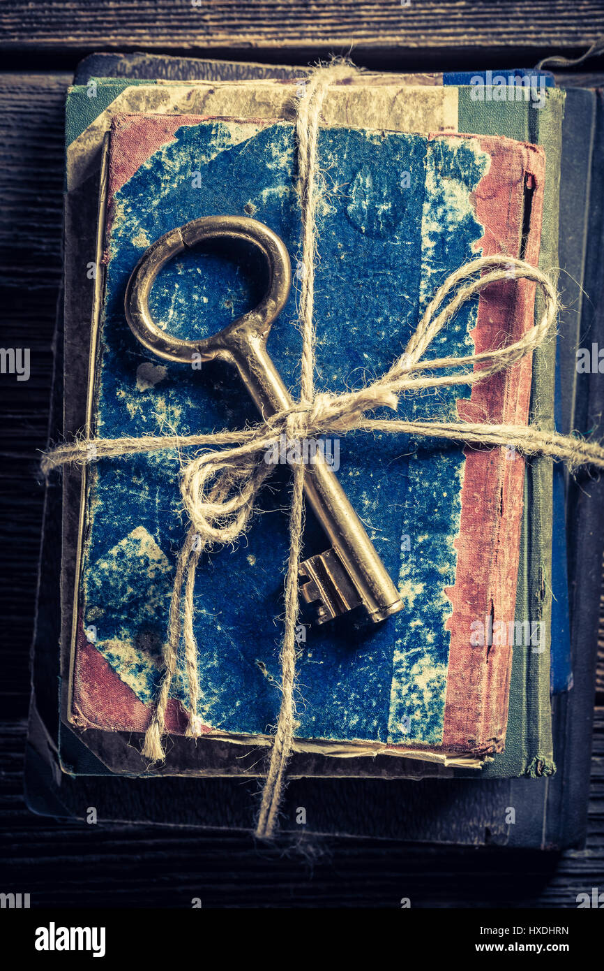 Vintage books and keys on old wooden table Stock Photo - Alamy
