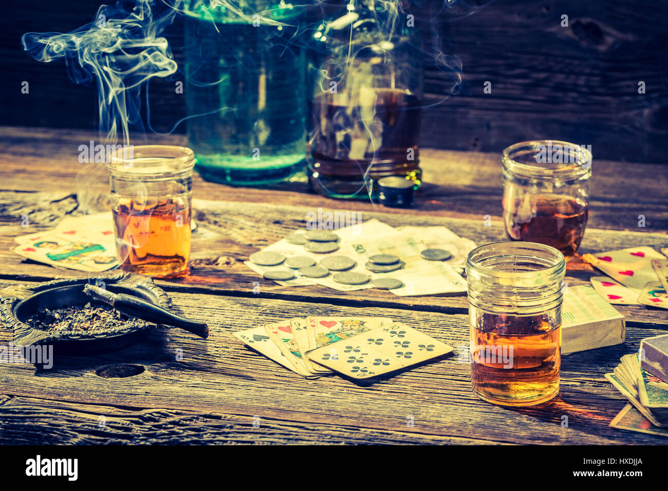 Vintage illegal gambling table with vodka, cigarettes and cards Stock ...