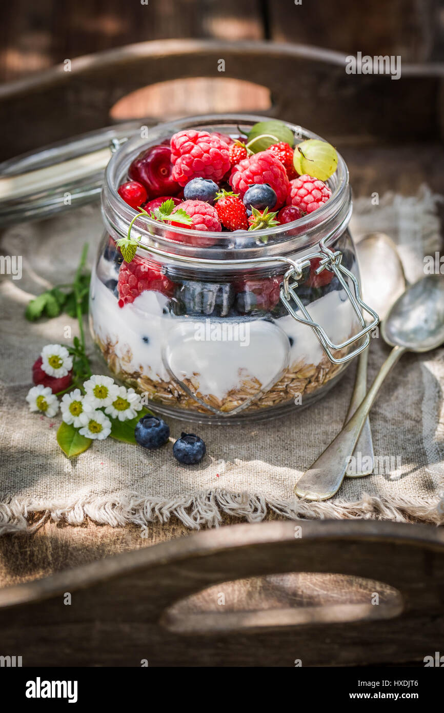Granola and yogurt decorated with flowers in garden Stock Photo - Alamy