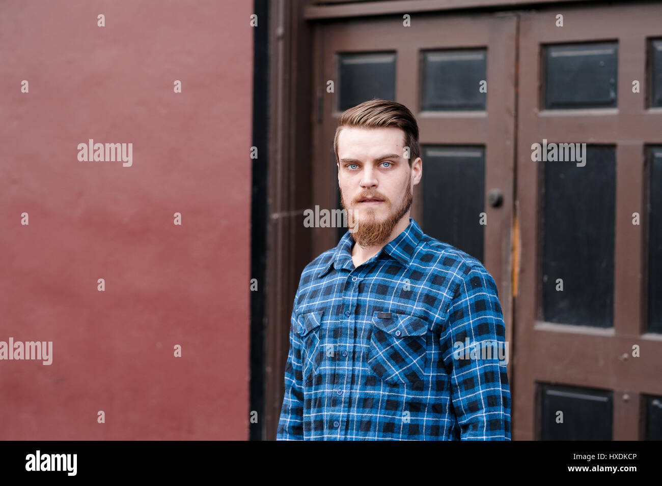 Hipster posing outdoors for the camera with a fashion forward style and ...