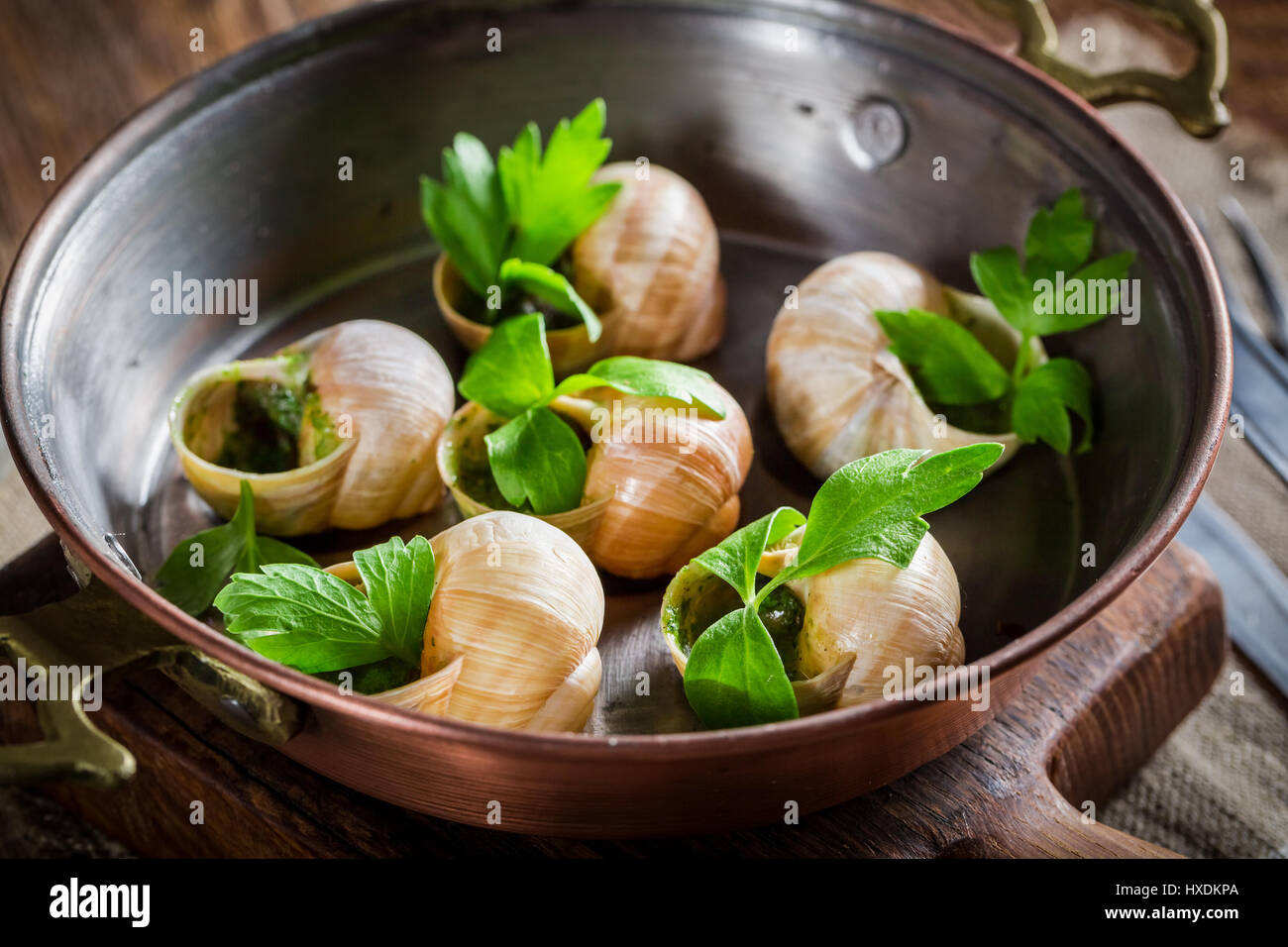 Roasted snails with garlic butter and parsley Stock Photo - Alamy