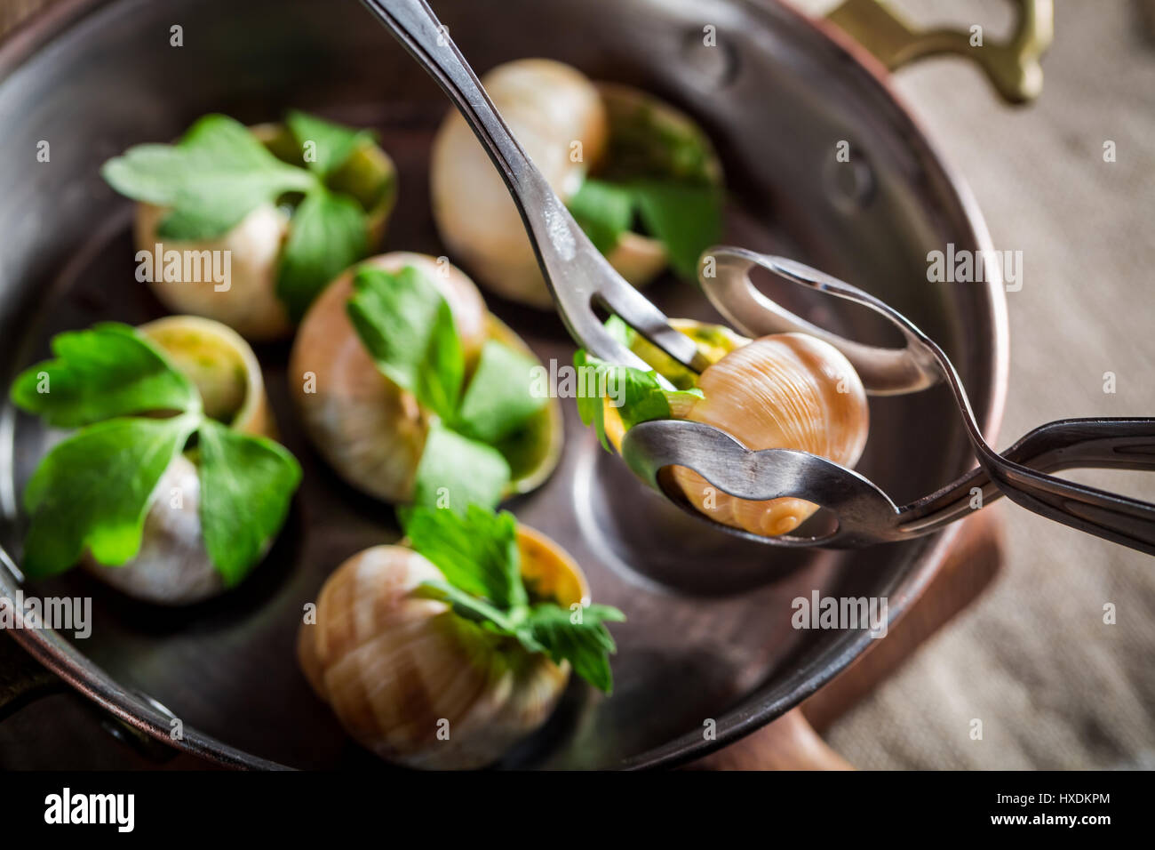 Eating roasted snails Stock Photo - Alamy