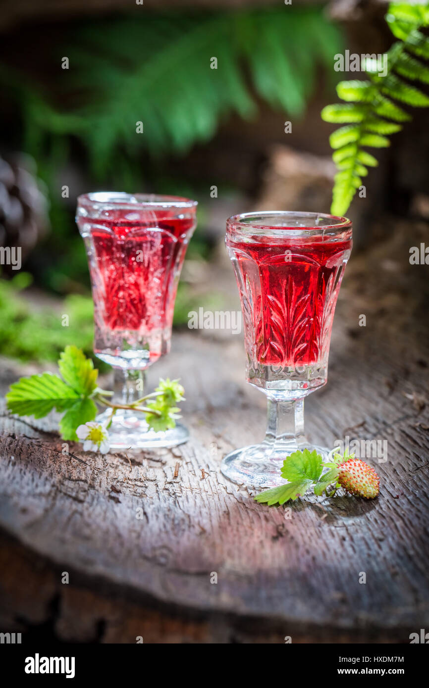Sweet liqueur with wild strawberry and alcohol Stock Photo - Alamy