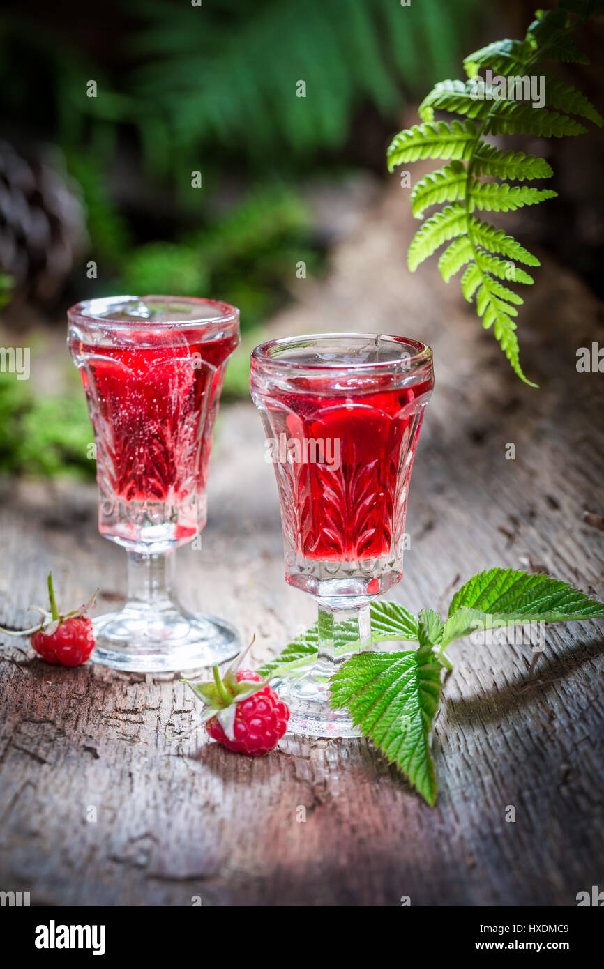 Fresh raspberries liqueur made of alcohol and fruits Stock Photo - Alamy