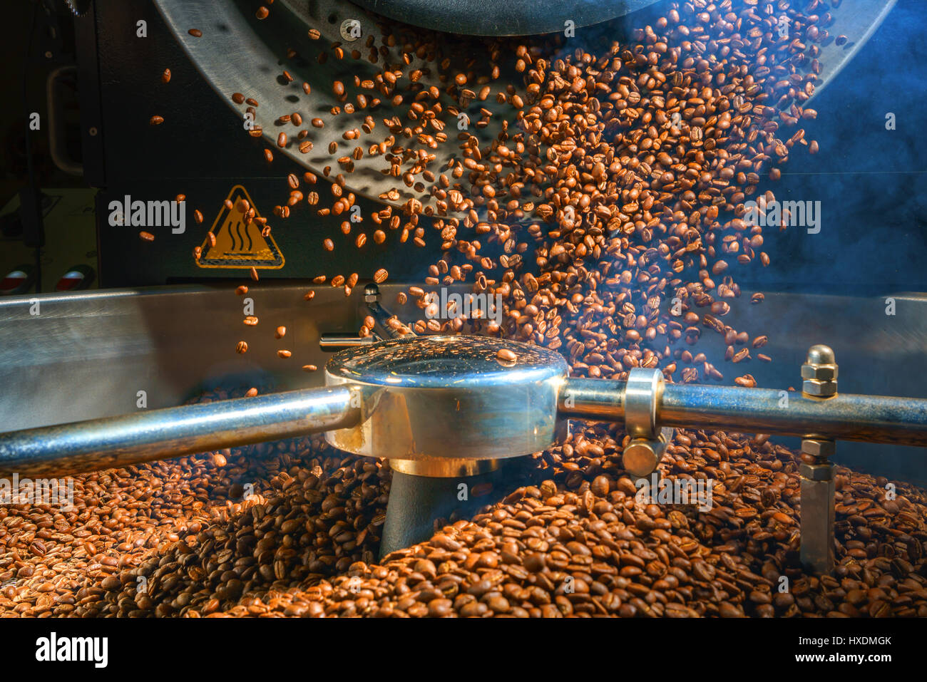 Mixing roasted coffee Stock Photo - Alamy