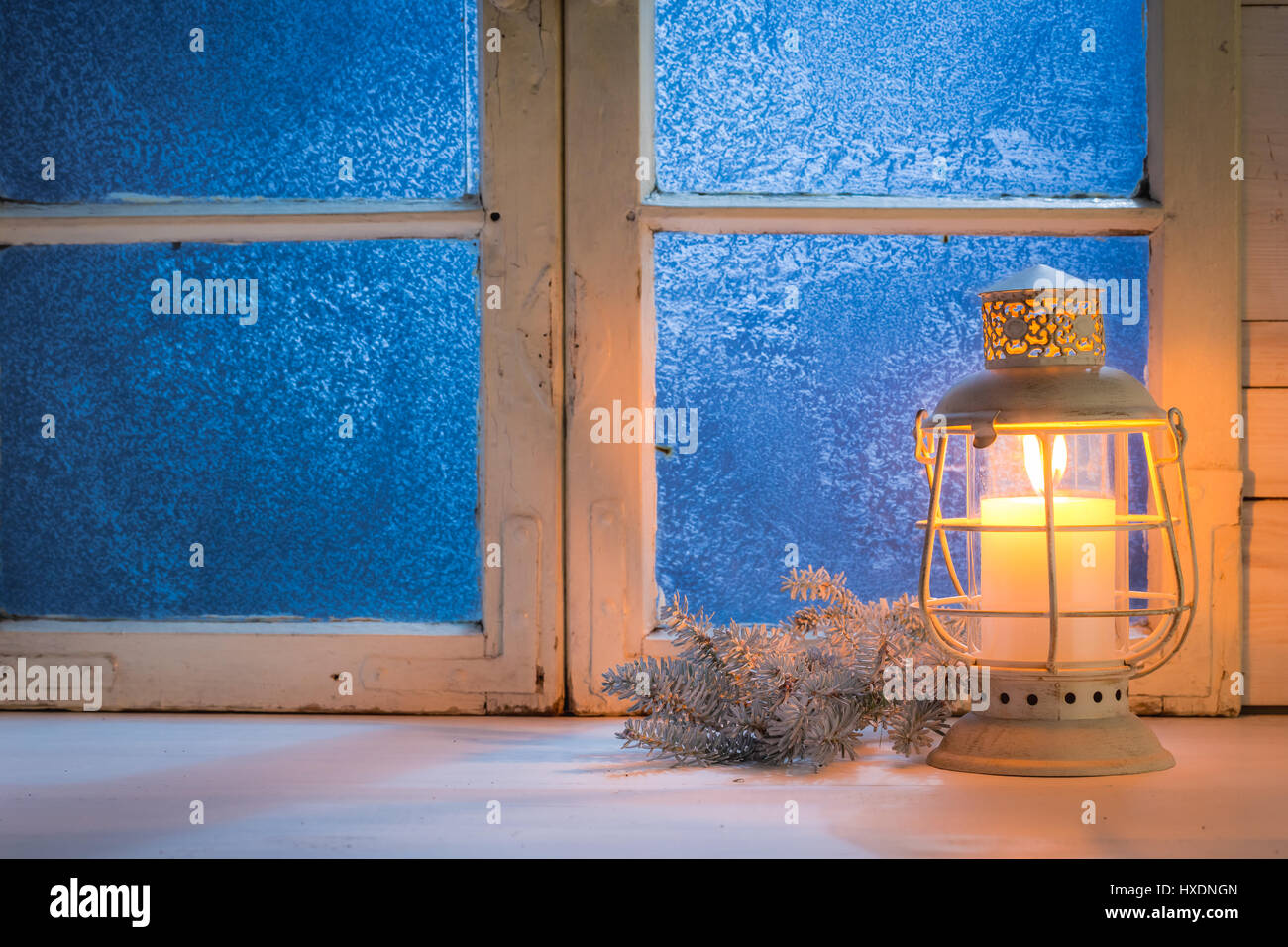 Frosted window with candle for Christmas Stock Photo - Alamy