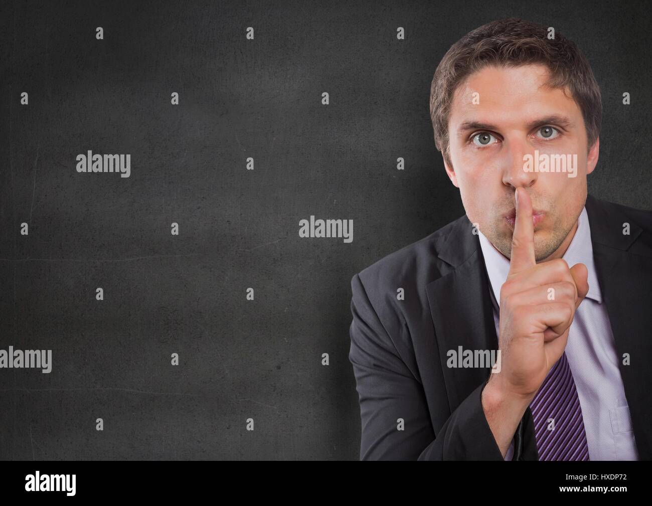 Digital composite of Business man finger over mouth against concrete ...