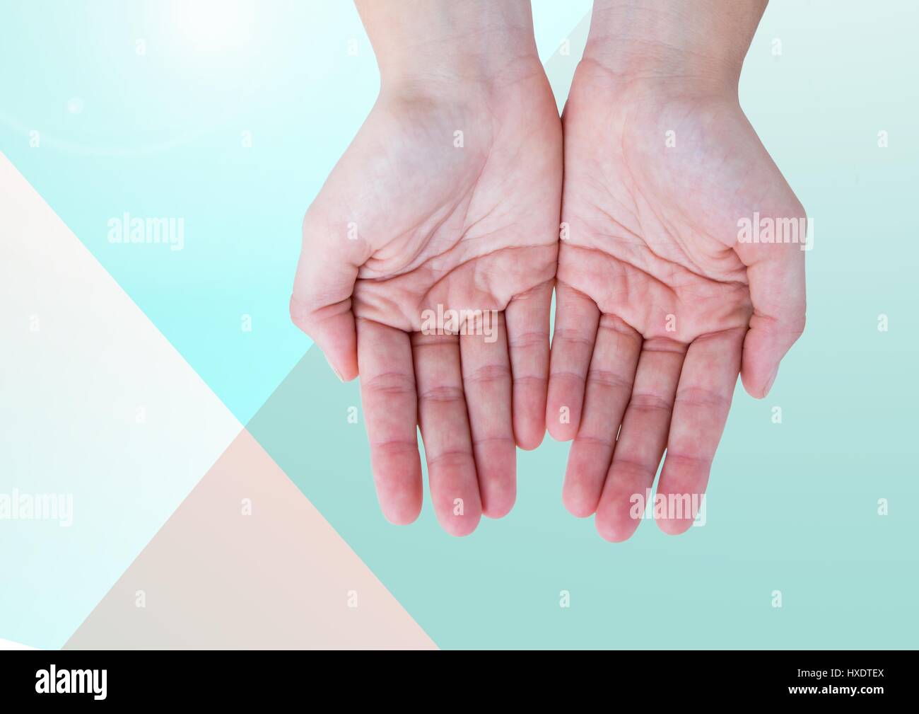 Digital composite of open hands together against blue background Stock ...