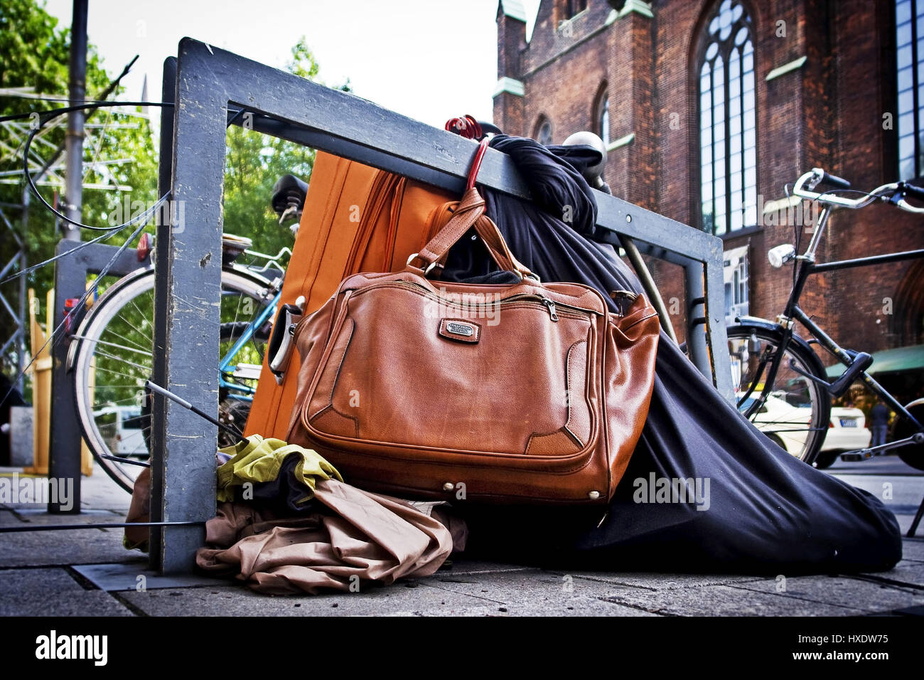 Belongings of a homeless, chained in a bicycle stand, Belongings of a ...