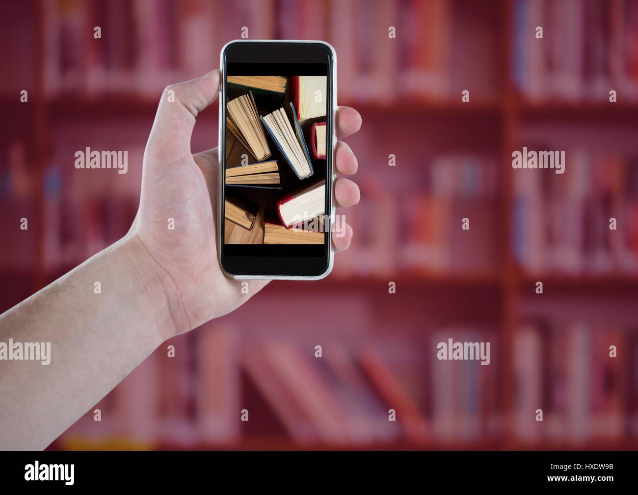 Digital composite of Hand with phone showing standing books against ...