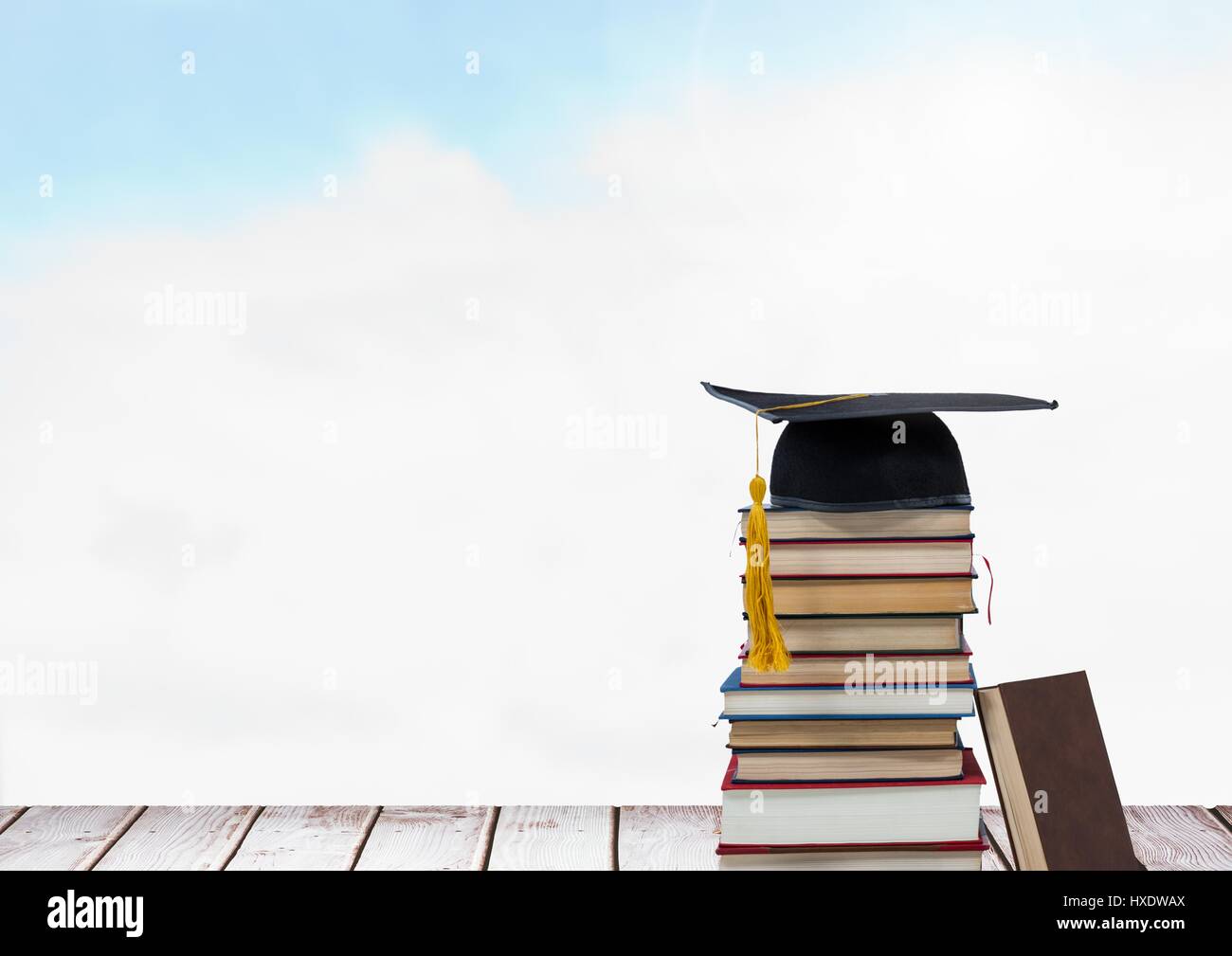 Digital composite of Books stacked by blue sky Stock Photo - Alamy