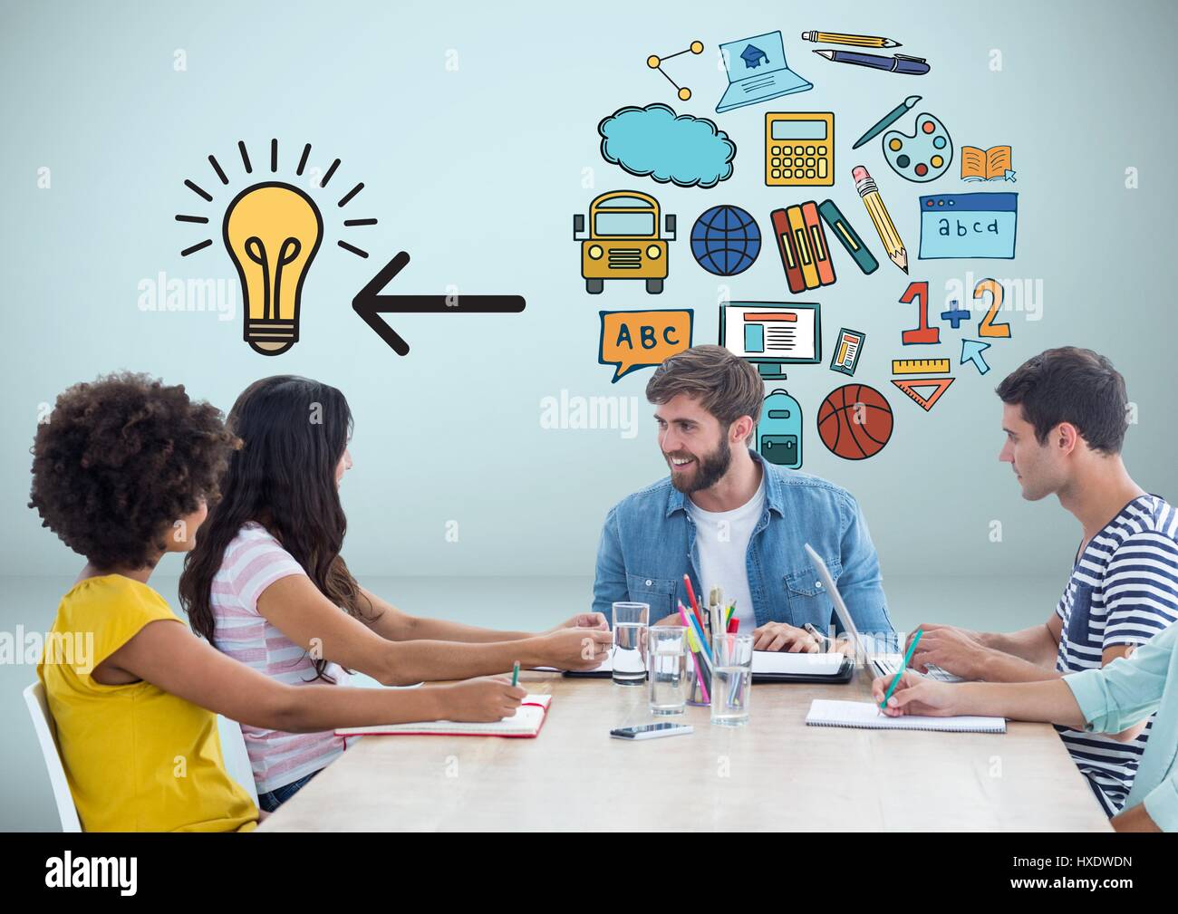 Digital composite of People at desk together with education ideas ...