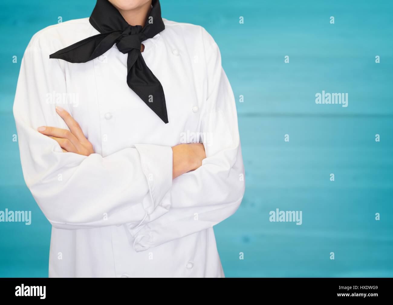 Digital composite of Chef arms folded against blurry blue wood panel ...