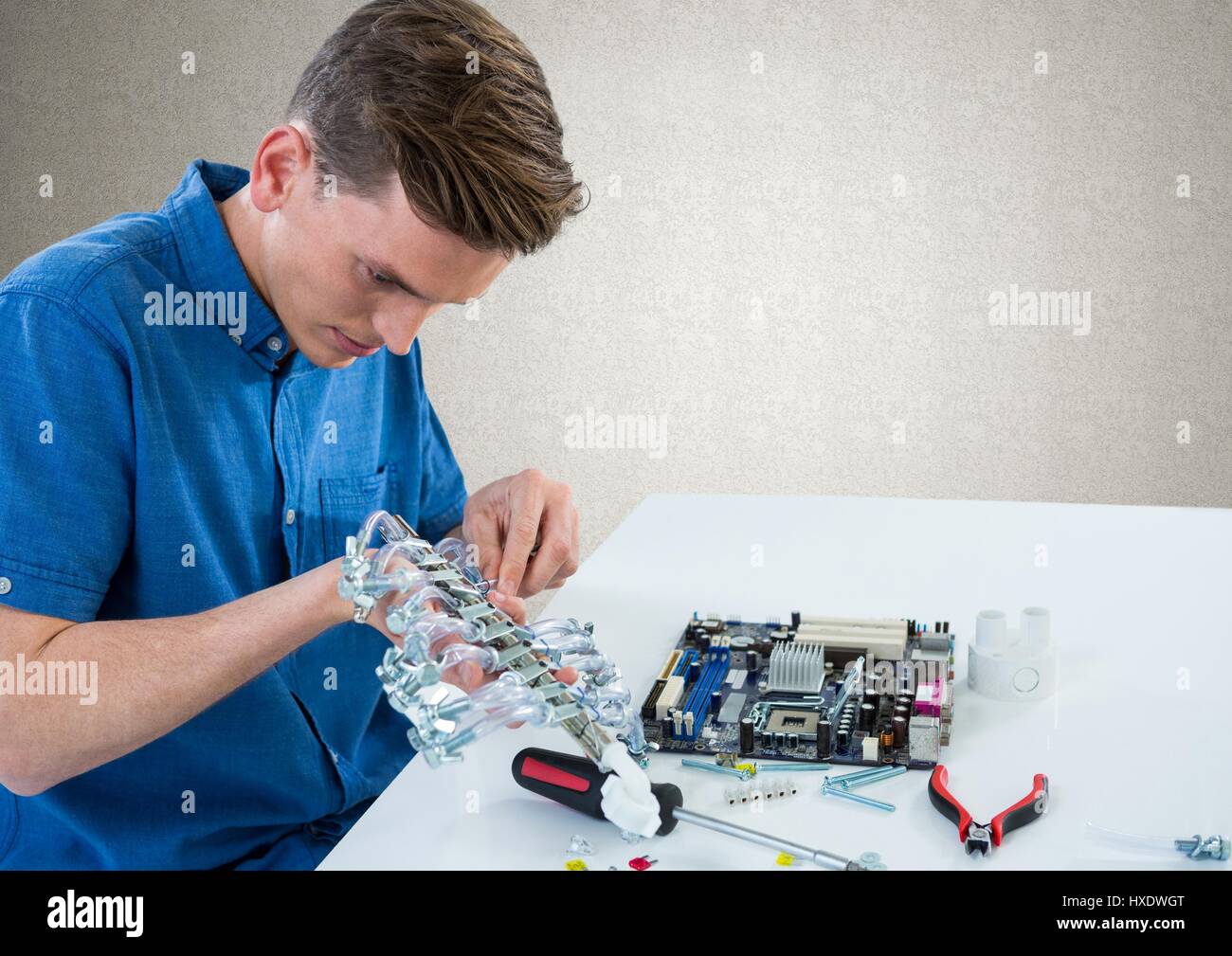 Digital composite of Man with electronics against grey wall Stock Photo ...