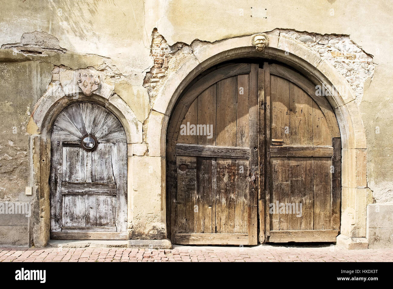House front with an old entrance and gate, front of the house with in ...