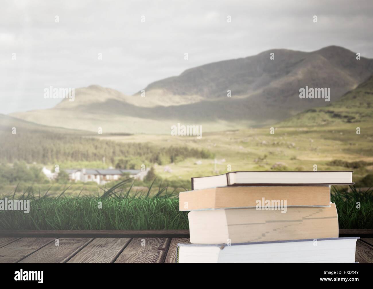 Digital composite of Books stacked by landscape mountains Stock Photo ...