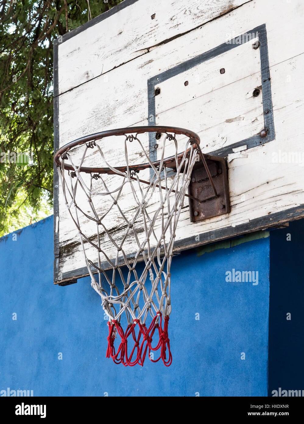 Old basketball hoop with the rusty on the blue wall of the public park ...