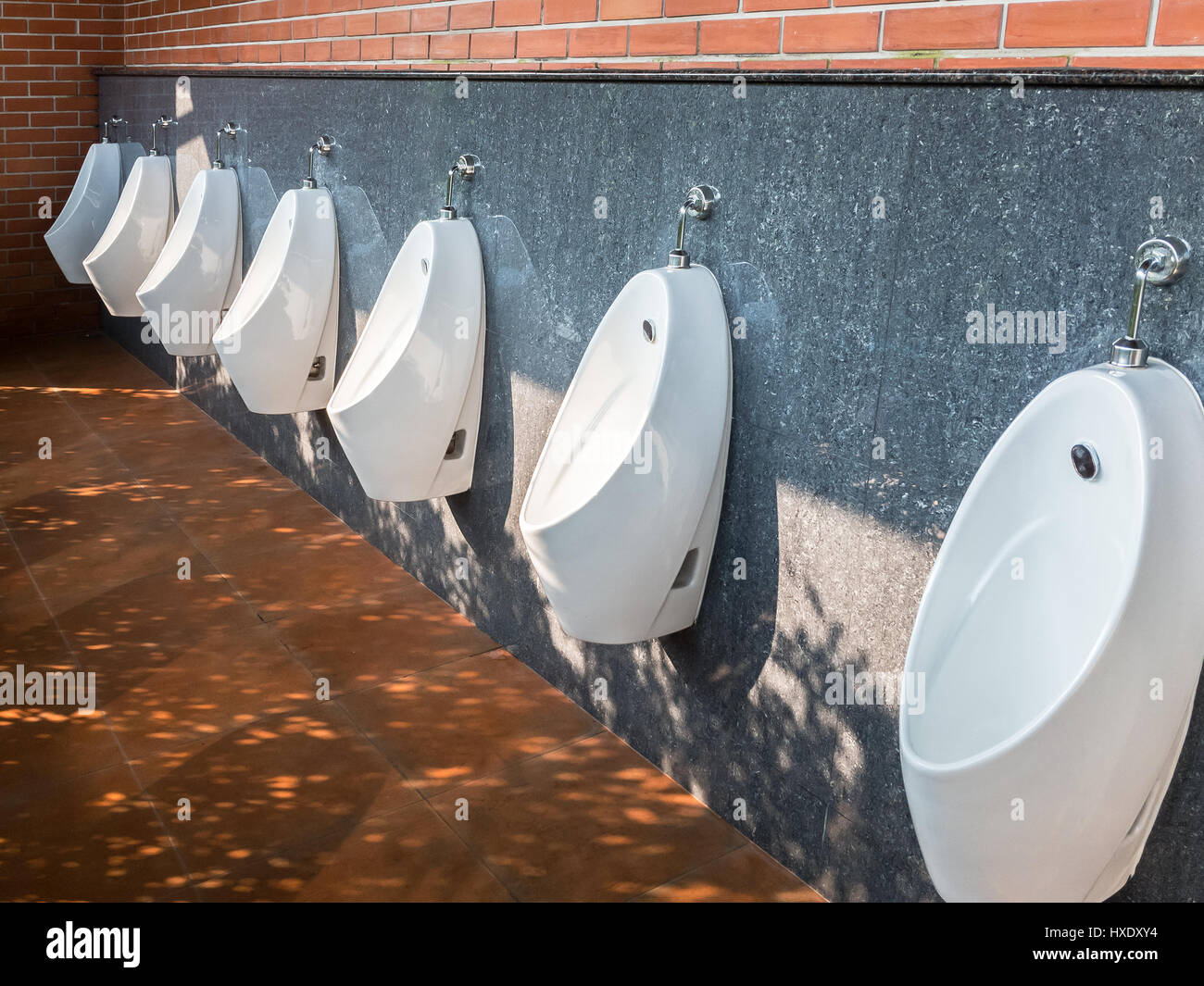 Modern urinals row in the back side of the clean public toilet Stock ...