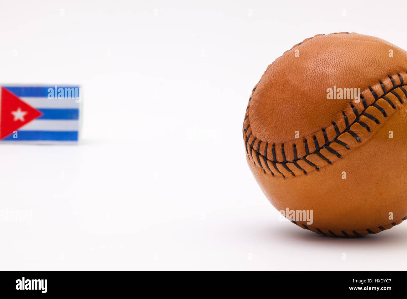 Leather baseball ball and Cuban flag on the white table Stock Photo - Alamy