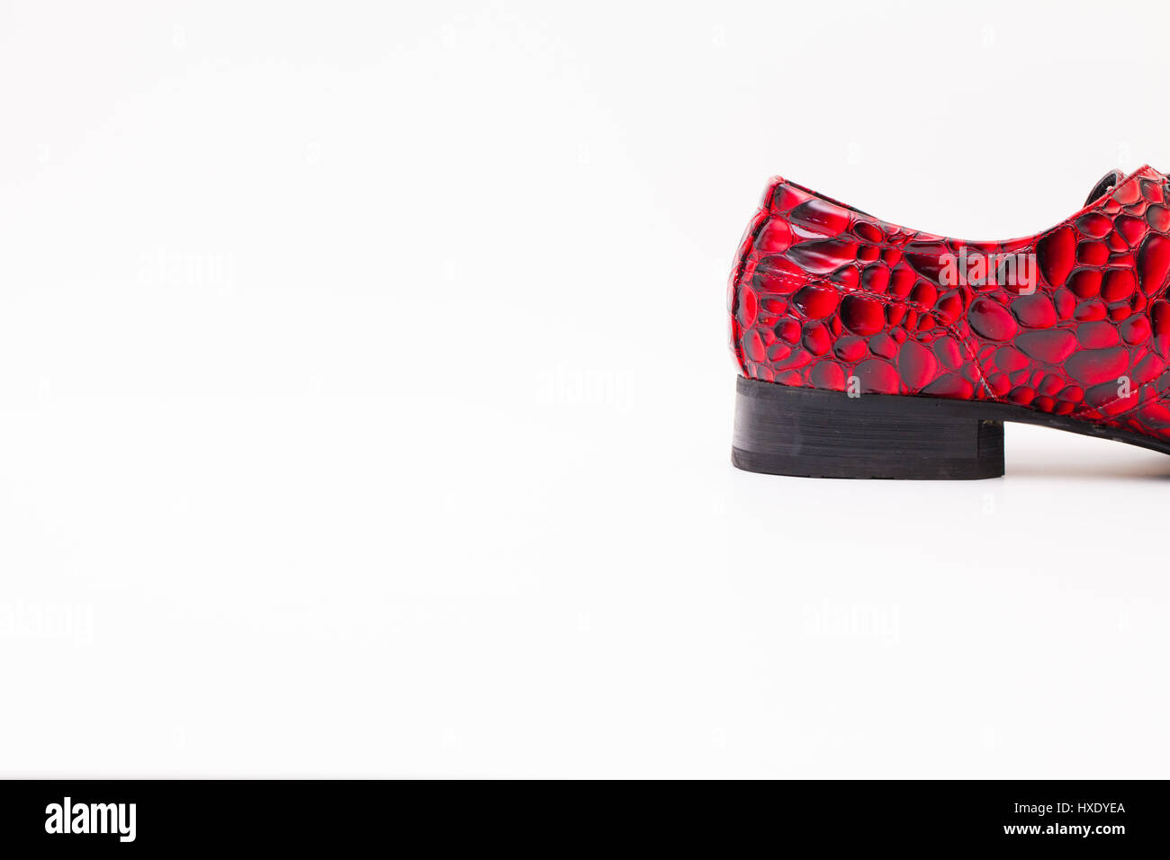 Detail of men's red shoes on white background Stock Photo - Alamy