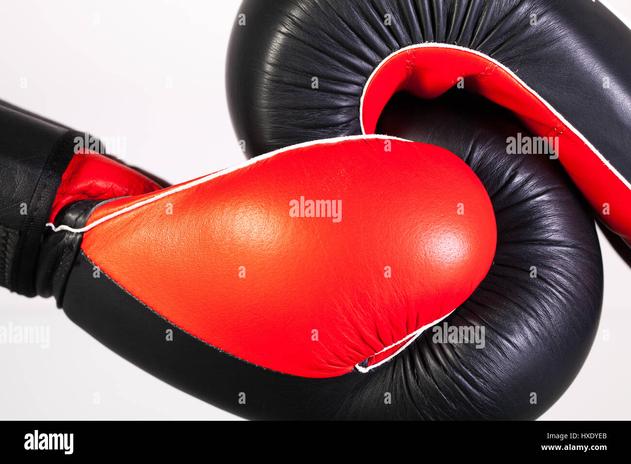 Red and black boxing gloves on a glass table isolated on white ...