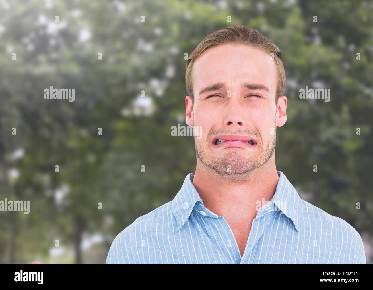 Digital composite of Man crying against trees Stock Photo - Alamy
