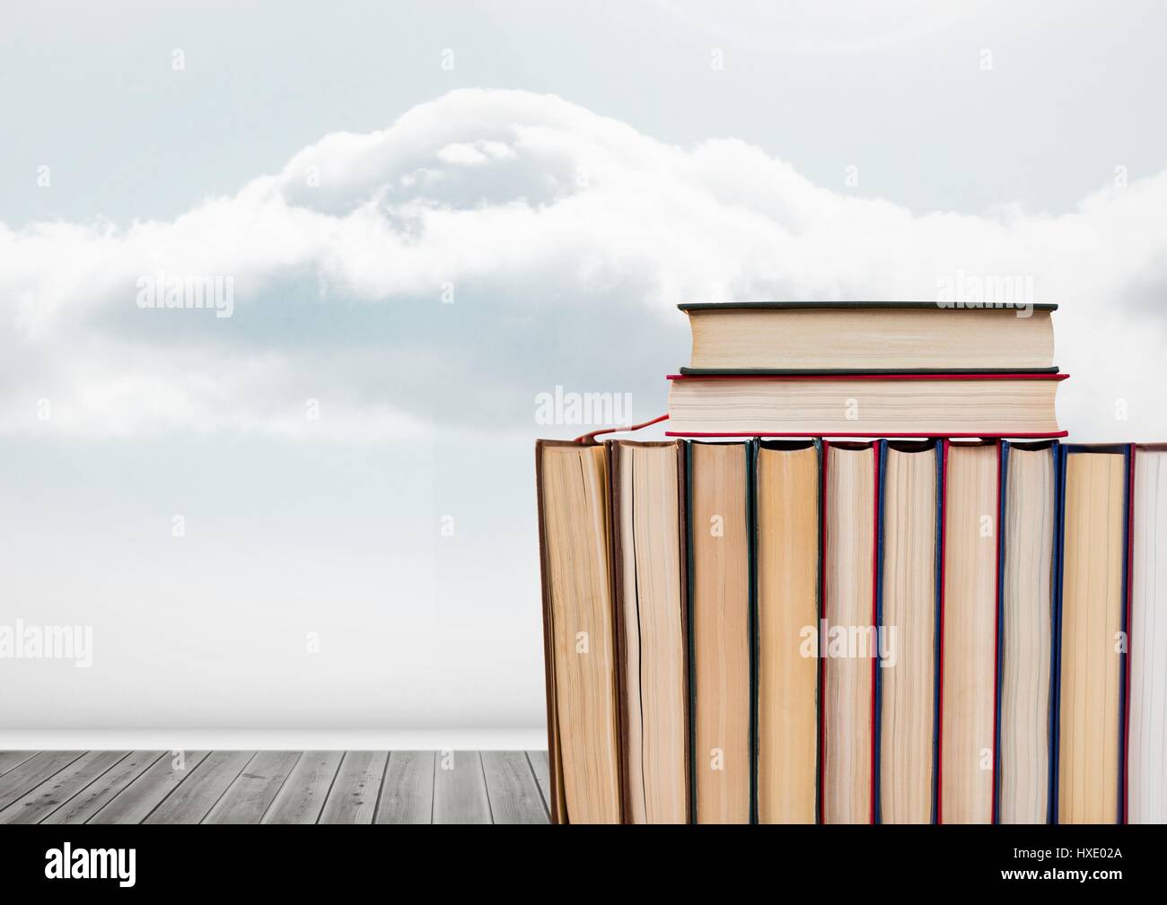 Digital composite of Books stacked by cloudy sky Stock Photo - Alamy